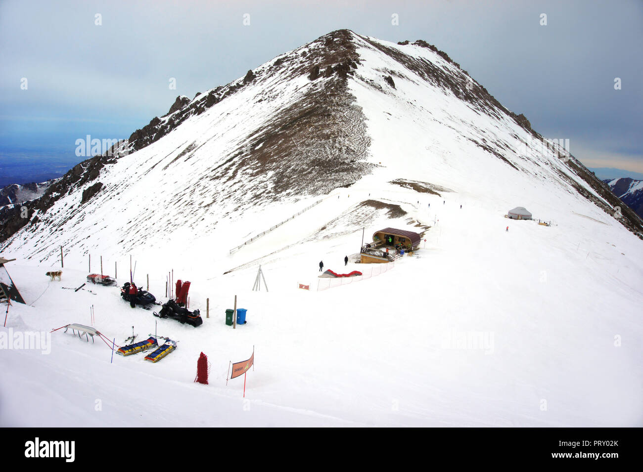 high snowy mountains in cloudy day, mounting skiing resort Shymbulak or ...