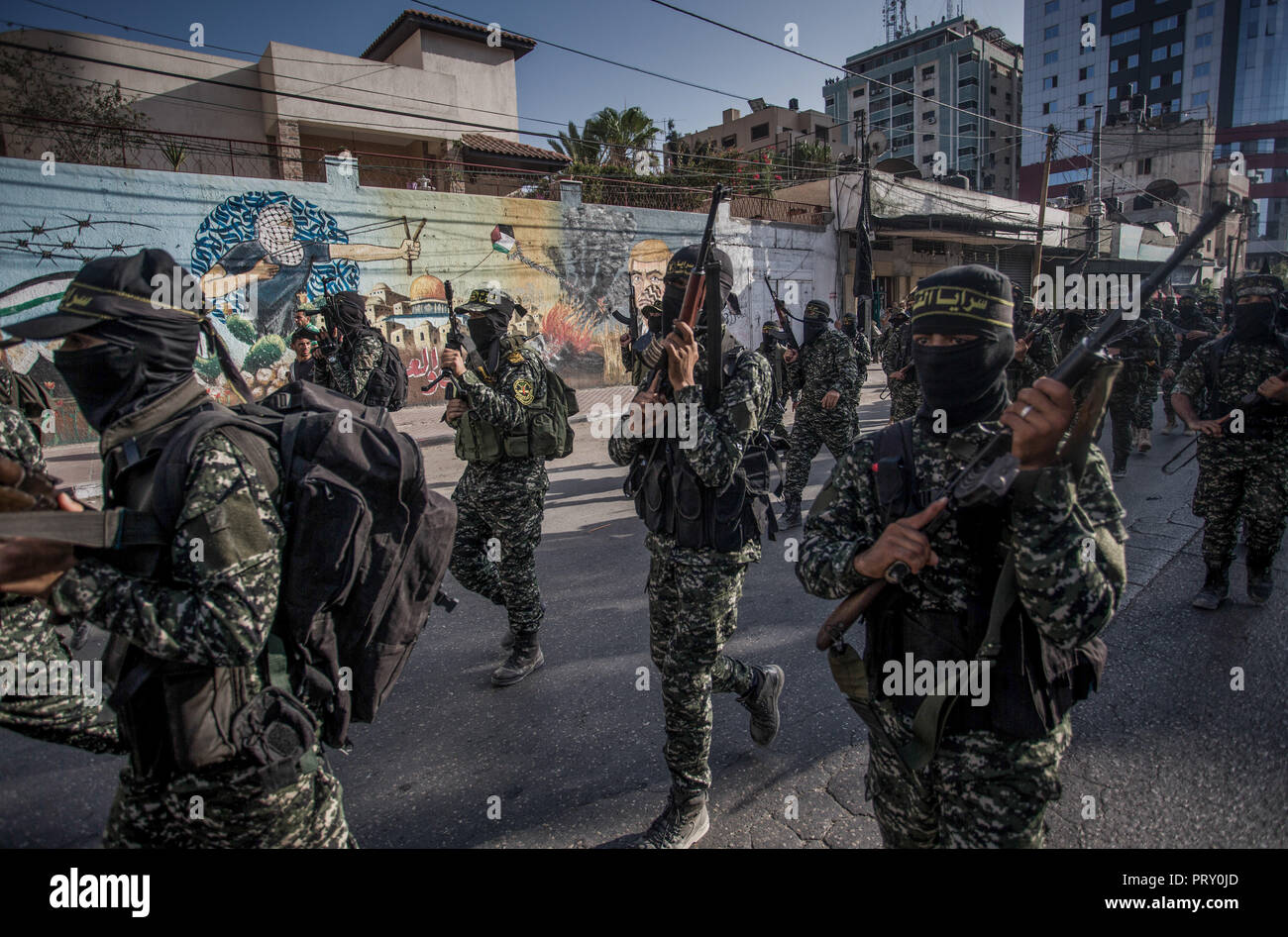 Military officers are seen walking holding guns during the march ...