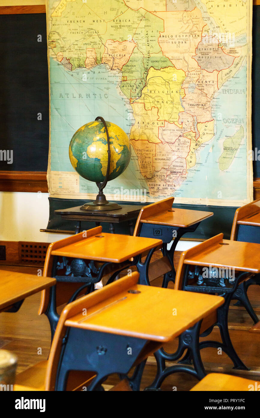 Empty desks at school classroom with globe and map Stock Photo - Alamy