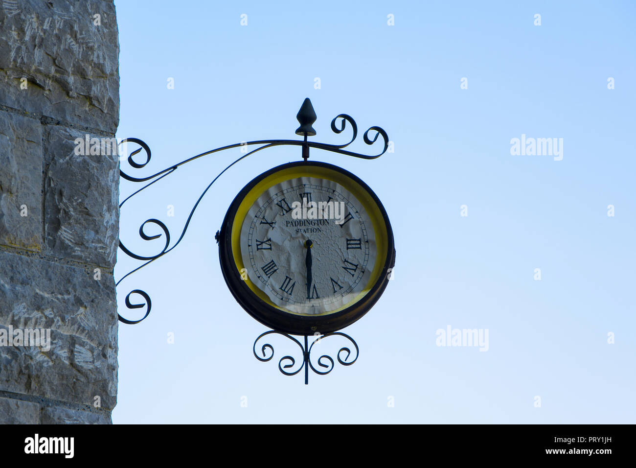 Old fashioned wall clock with "Paddington station" text inside against ...