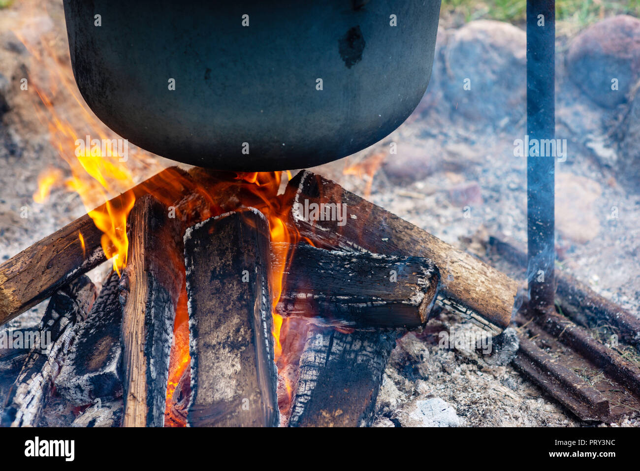Closeup of food pot hangs over burning fire Stock Photo - Alamy