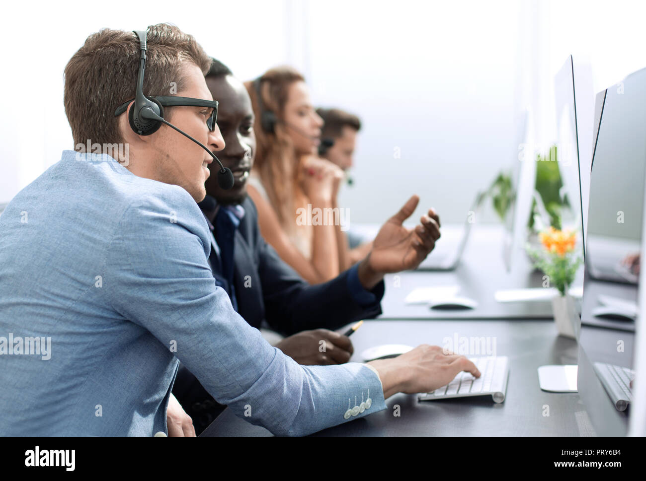 call center operators are talking, sitting at his Desk Stock Photo - Alamy