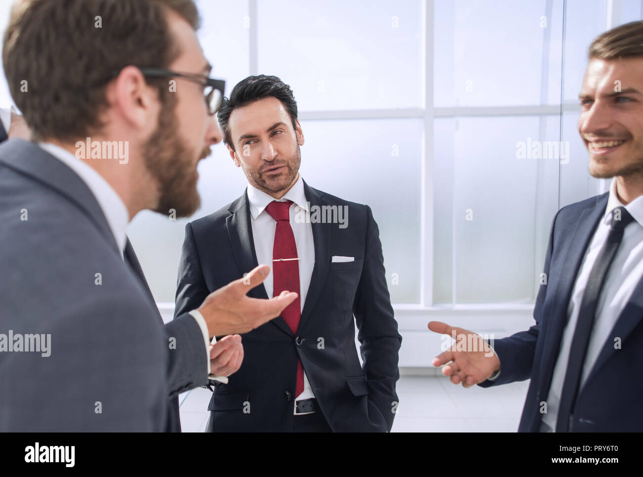 Manager and employees of the company talking standing in the office ...