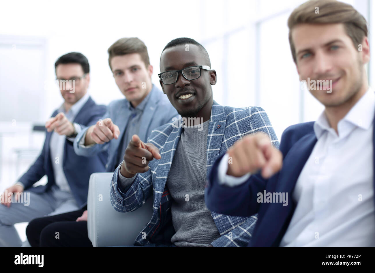 group of successful young men pointing their fingers at you Stock Photo ...