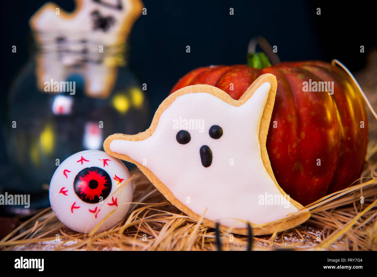 Fresh homemade decorated halloween cookies and sweets on dark ...