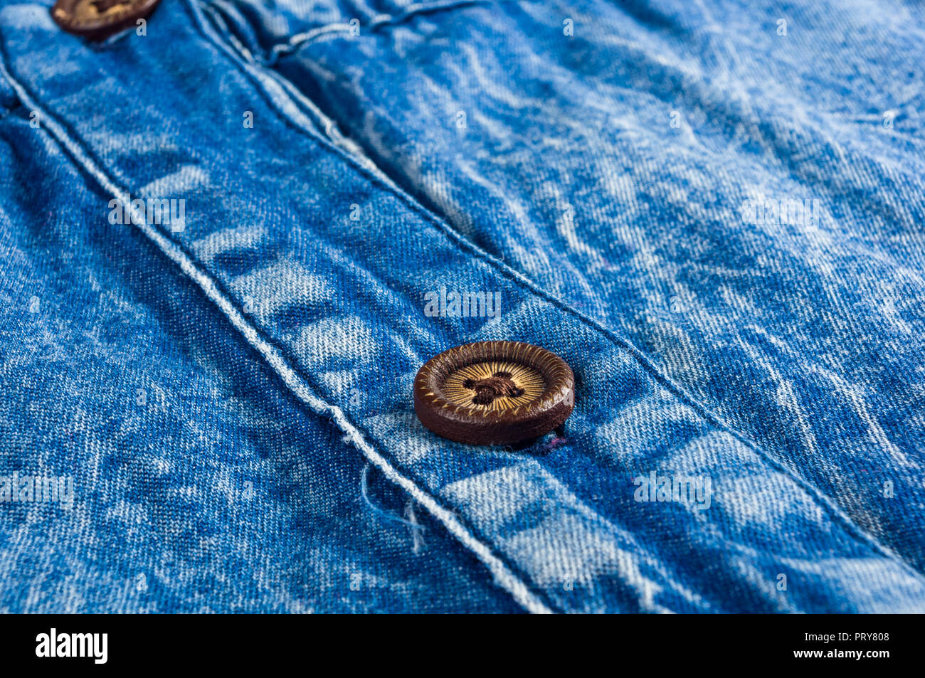 Blue washed faded jeans texture with seams, clasps, buttons and rivets ...