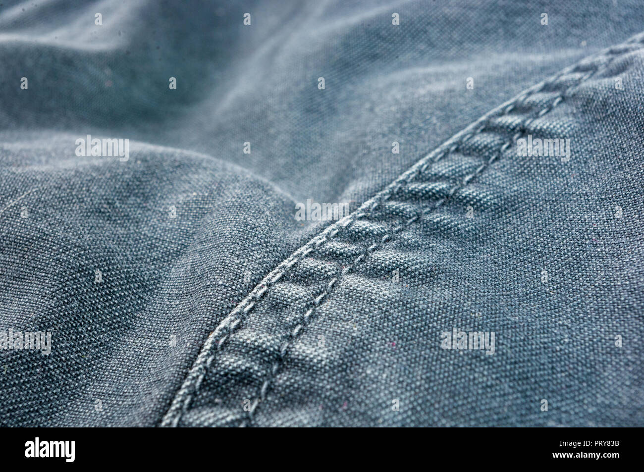 clothing items washed cotton fabric texture with seams, macro, close-up ...