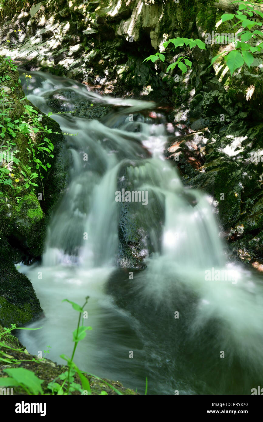 long exposure of a waterfall at Aira force waterfall park in the Lake ...