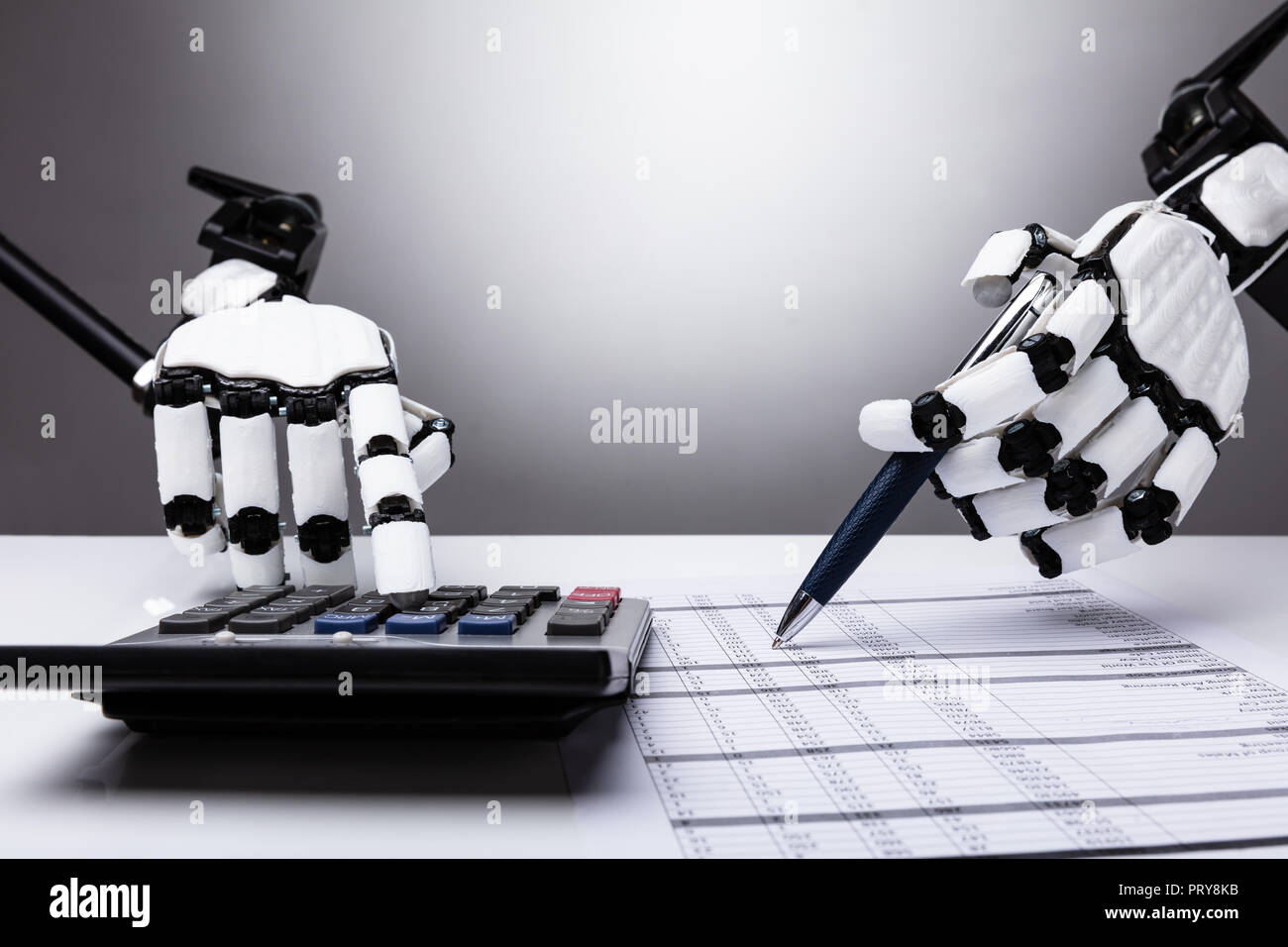 Close-up Of Robot Examining Financial Report With Calculator On Desk ...