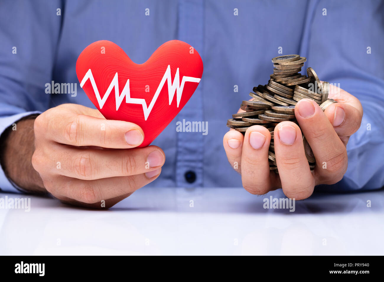 Hand holding heart coins hi-res stock photography and images - Alamy