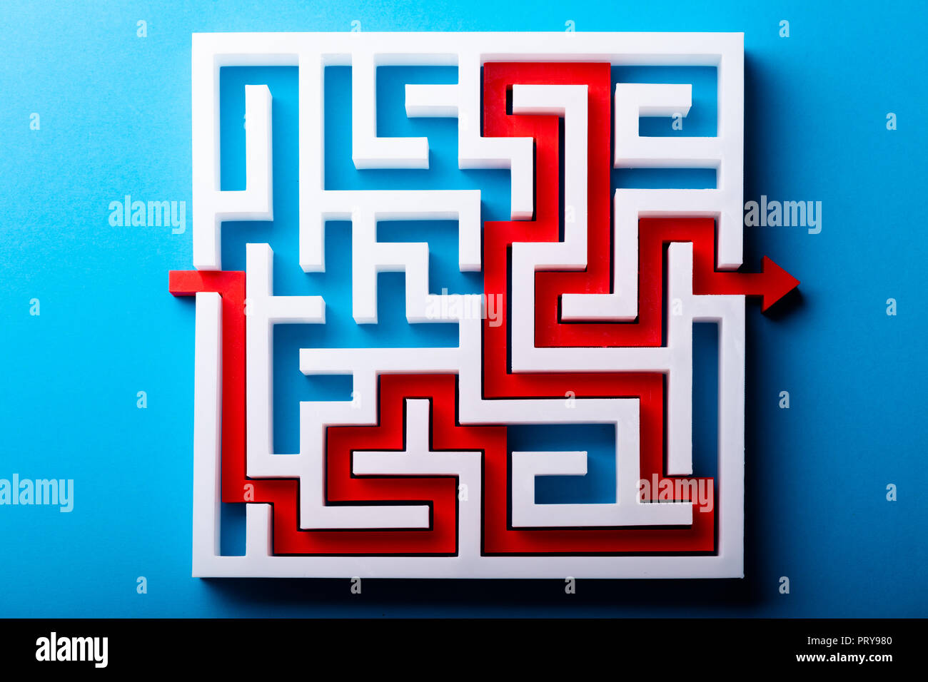 High Angle View Of Red Arrow Showing Path Through Maze On Blue ...