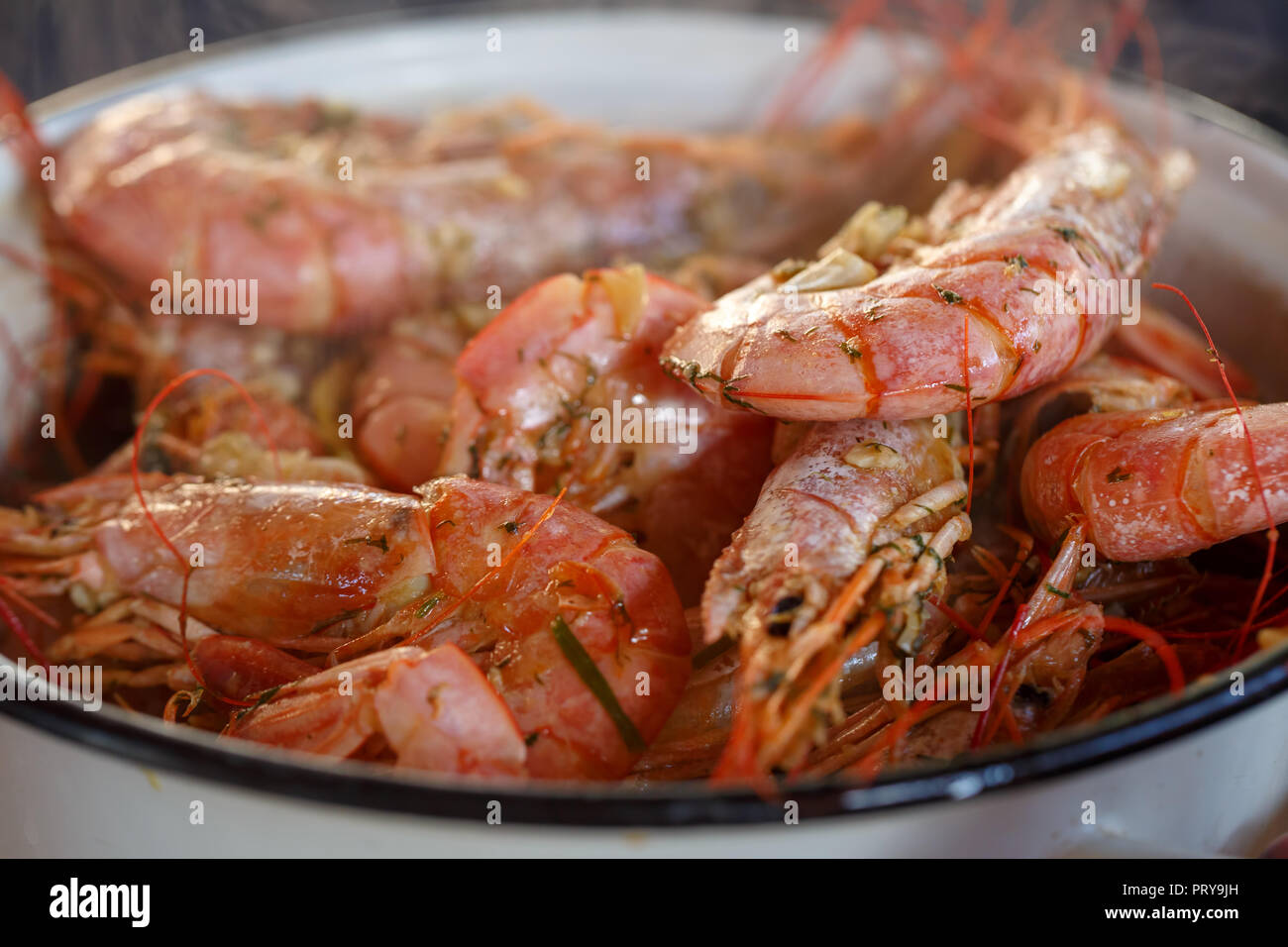 Large shrimps cooked on a grill lie in a saucepan close up Stock Photo ...