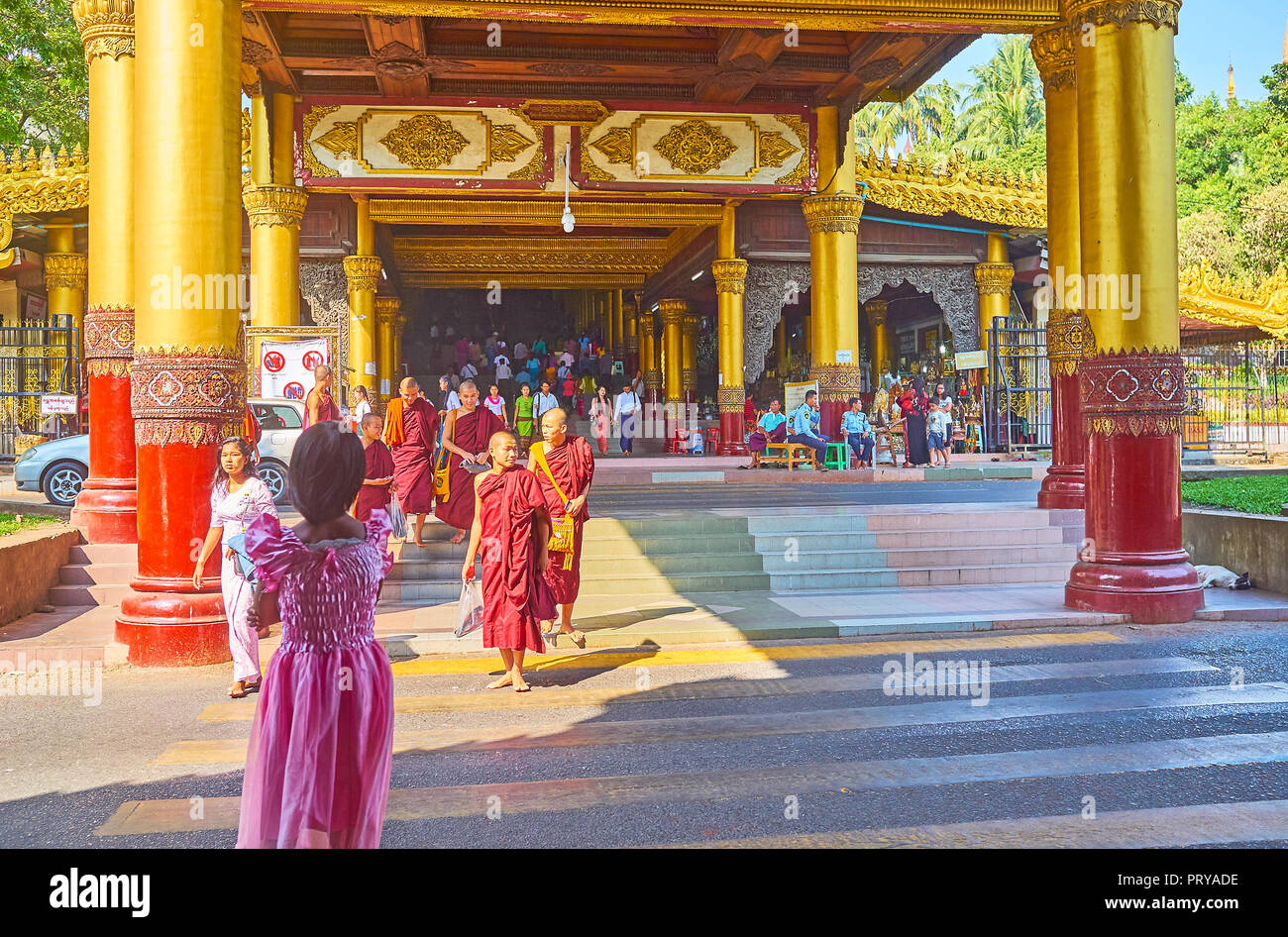 YANGON, MYANMAR - FEBRUARY 17, 2018: Pedestrians, crossing the road ...