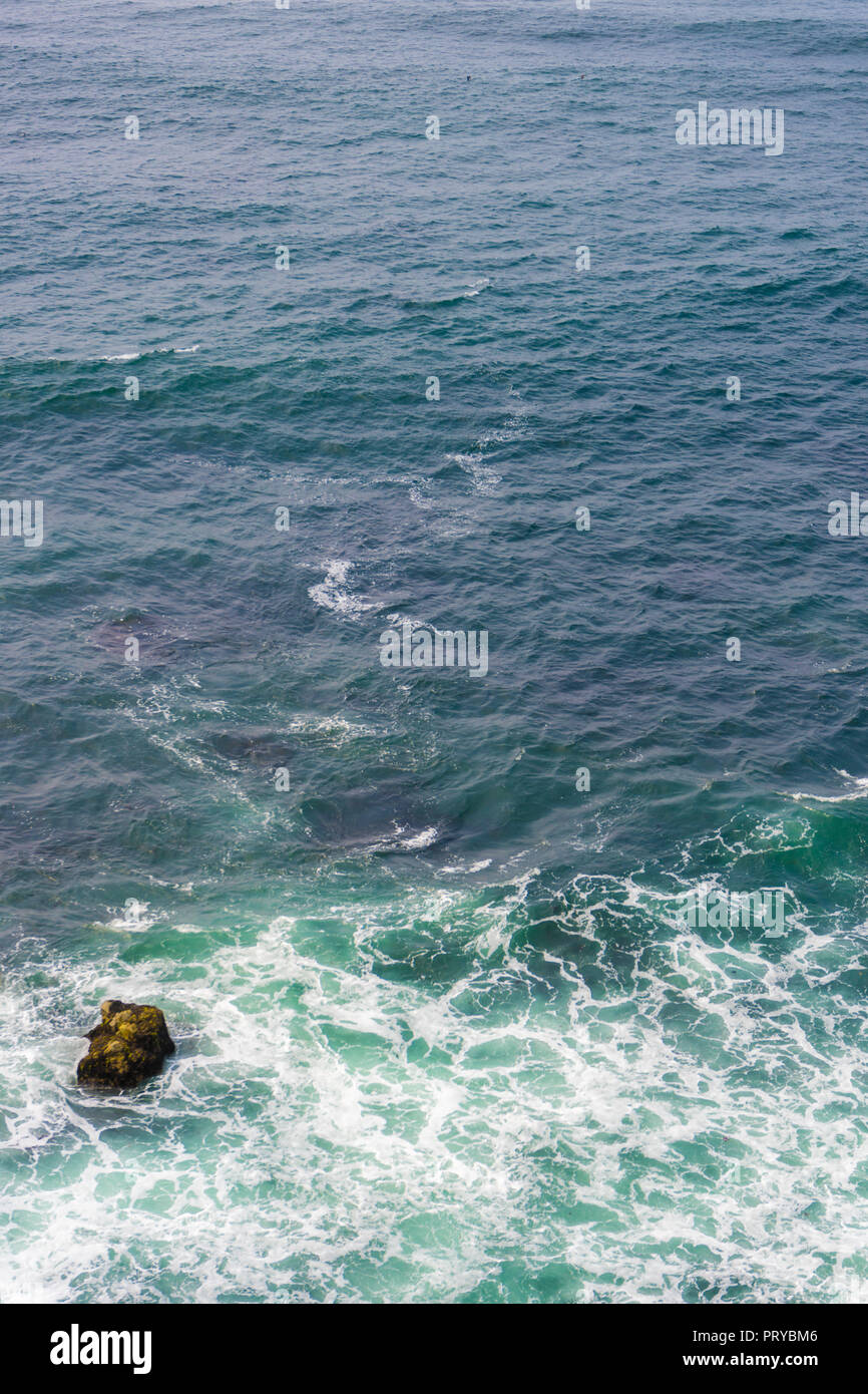 Ocean background with one isolated rock Stock Photo - Alamy