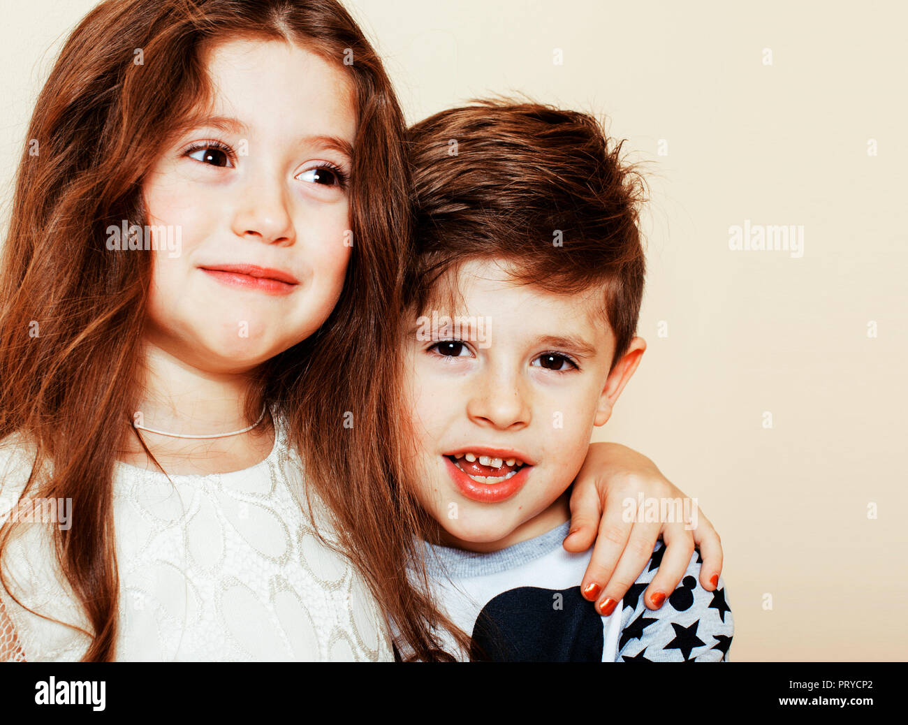 little cute boy and girl hugging playing on white background, ha Stock Photo - Alamy