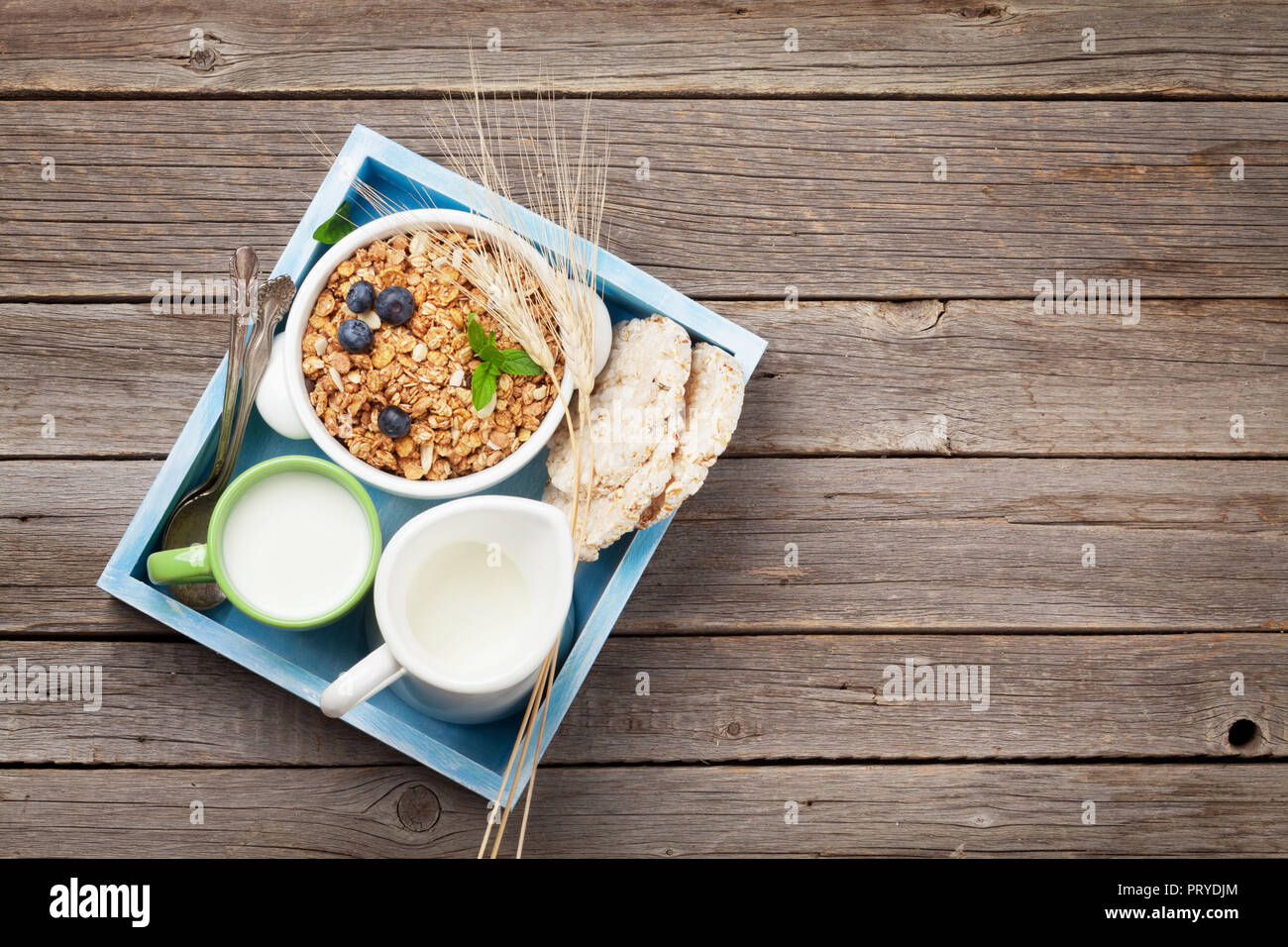 Healthy breakfast set with muesli, berries and milk. Top view with ...
