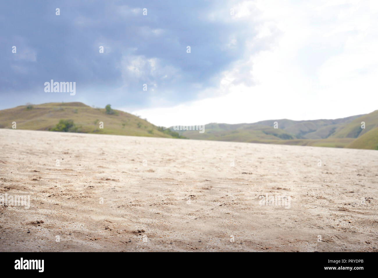 Sand dune with green hills view background Stock Photo - Alamy
