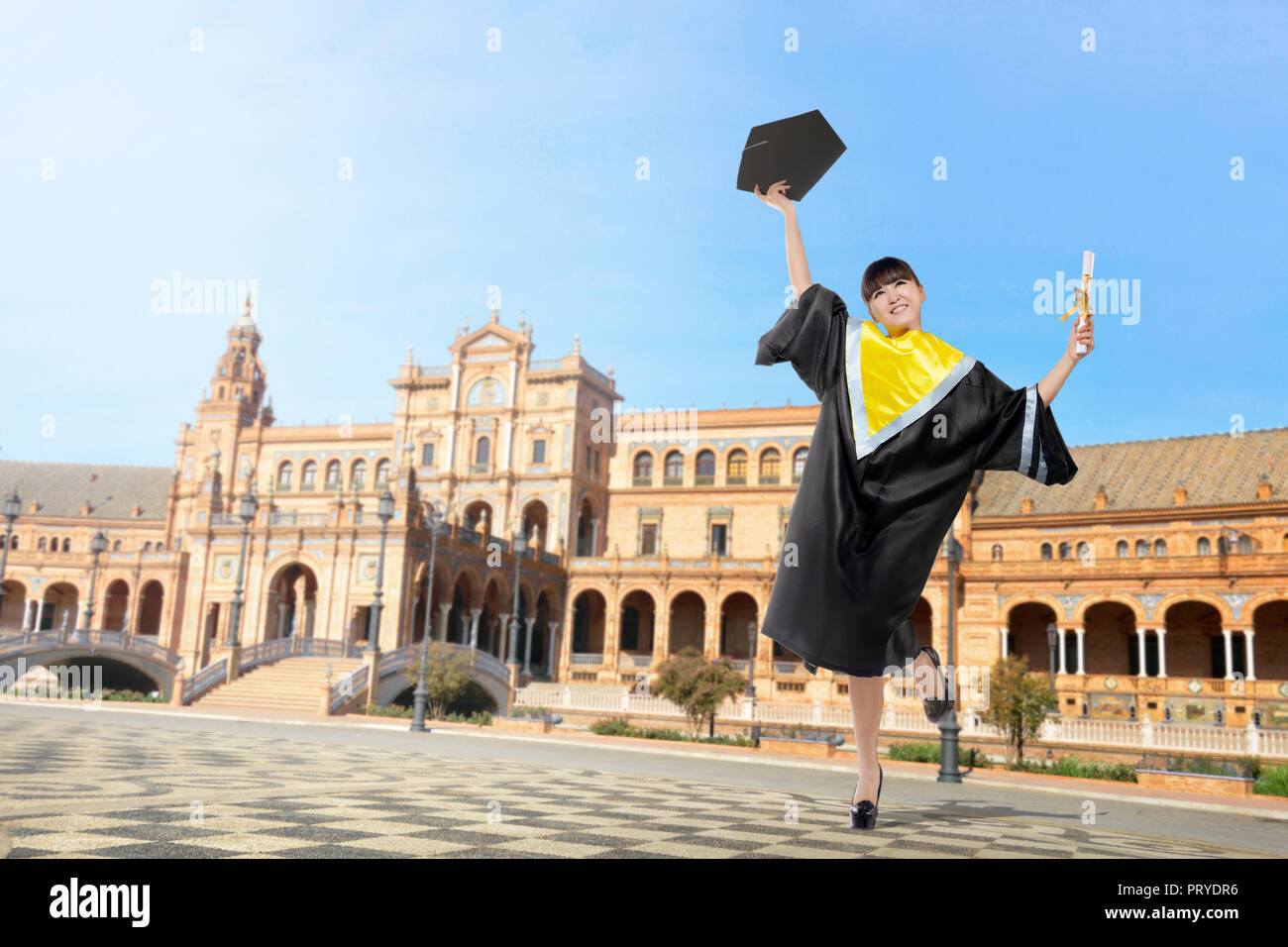 Young asian woman in graduation gown celebrate her graduation on the ...