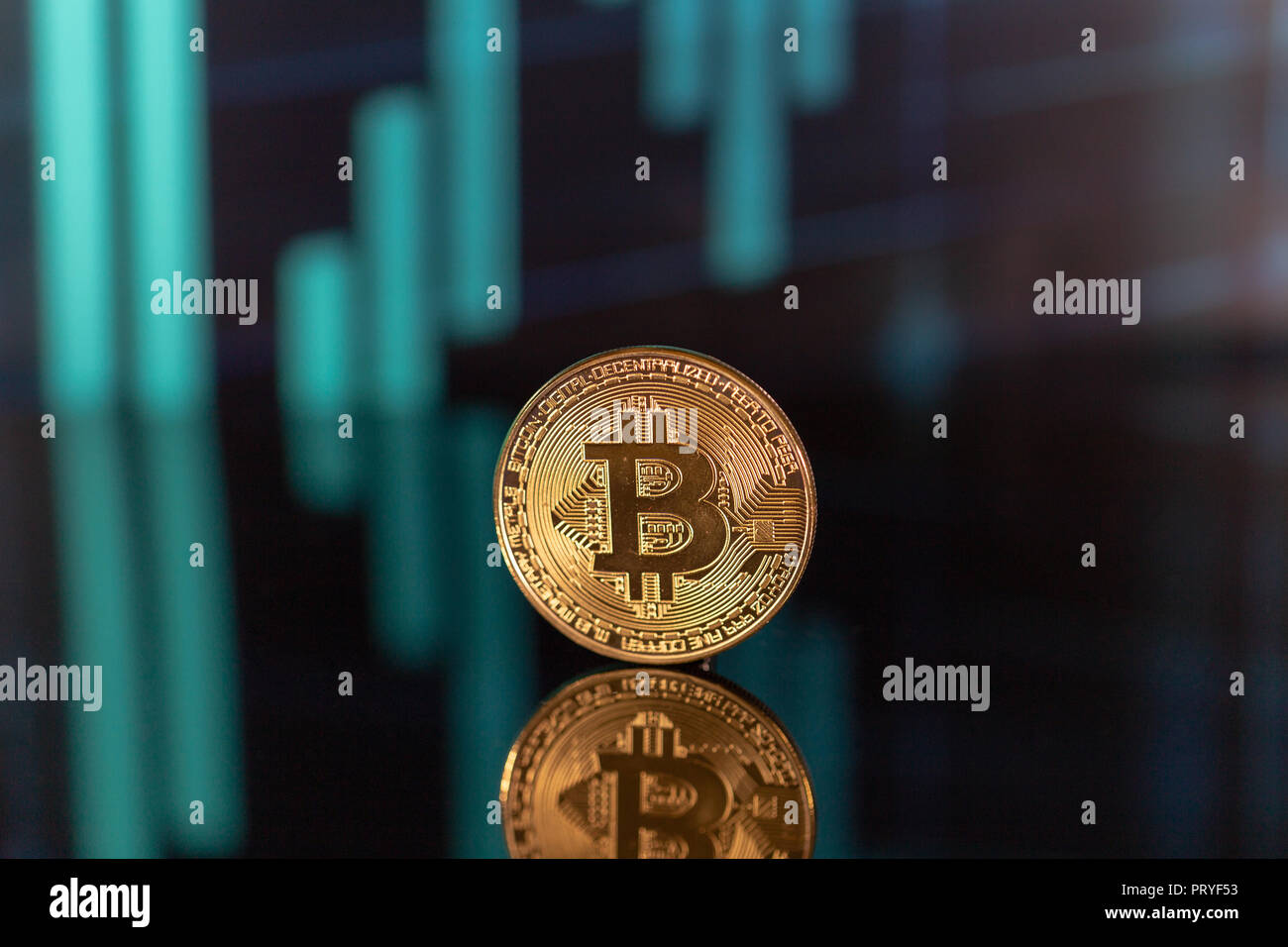 Gold bitcoin coin isolated on black background with reflection and ...