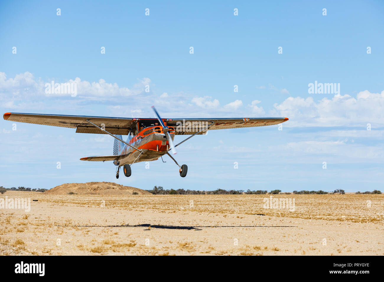 Cessna 170 lands on a sandy runway, Ganab Airfield, Namib Naukluft ...