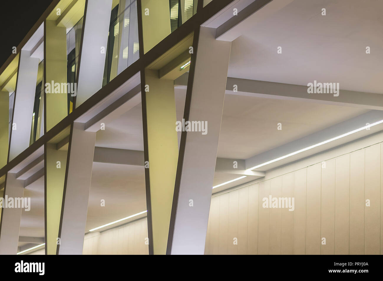 Yellow and White Modern Lit Building At Night Stock Photo - Alamy