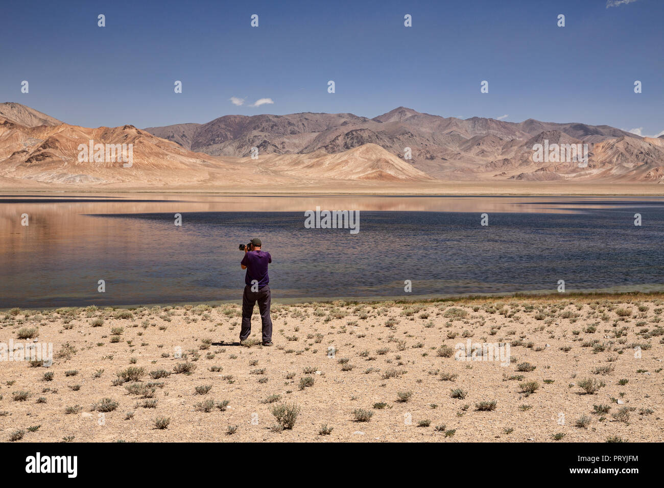 Photographer on the shores Rangul and Shorkul Lakes off the remote ...