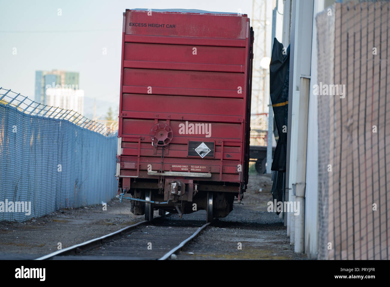 Red cargo railroad cart parked at the industrial center, waiting to be ...