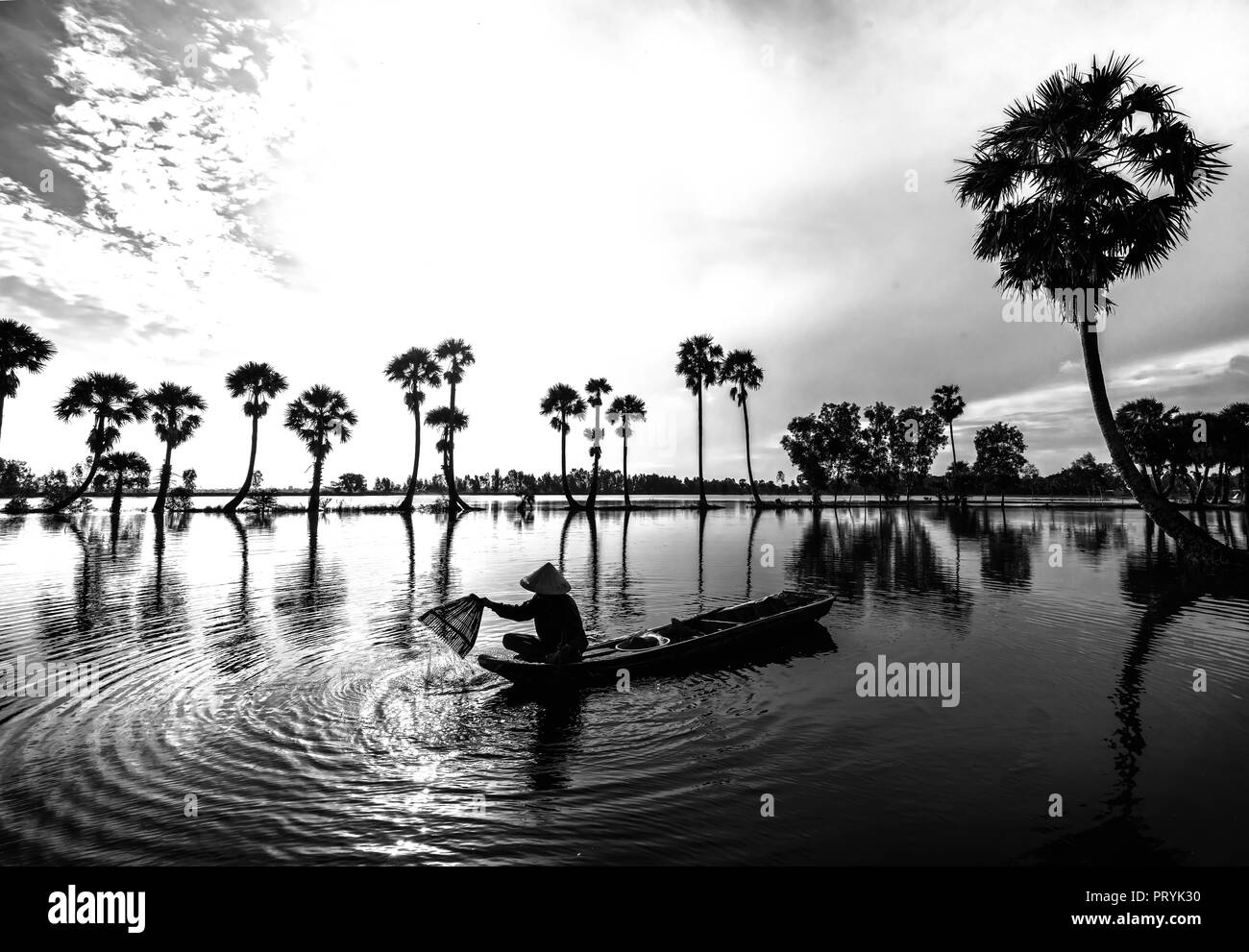 Unidentified fishers catch fish with bamboo tools in a lake when ...
