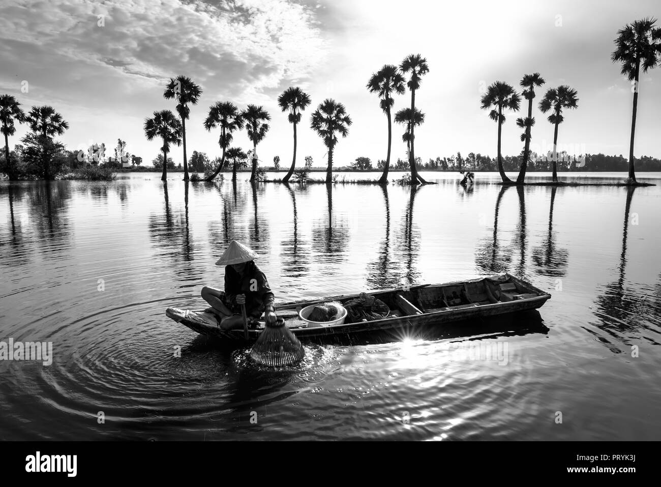 Unidentified fishers catch fish with bamboo tools in a lake when ...