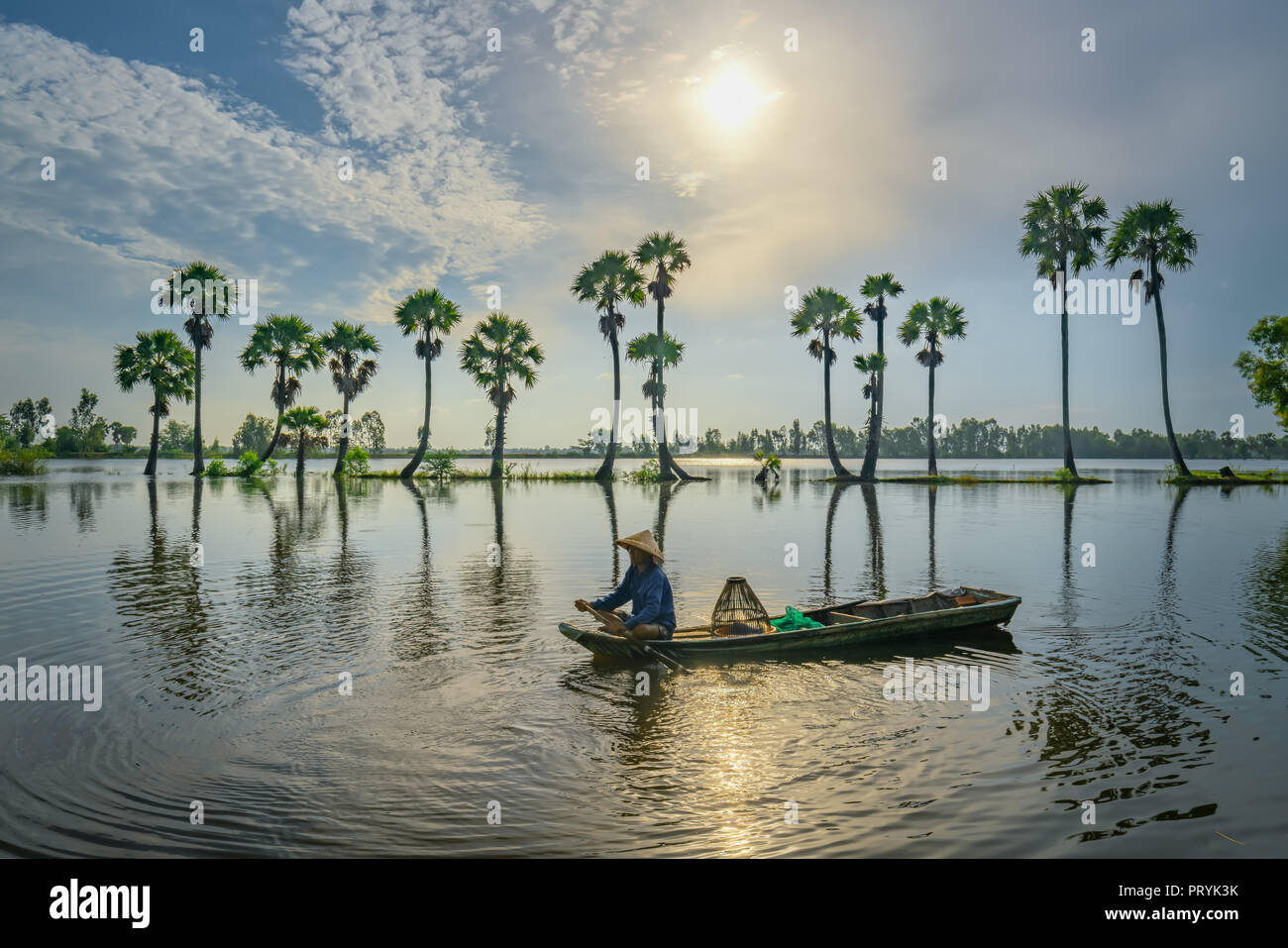Unidentified fishers catch fish with bamboo tools in a lake when ...