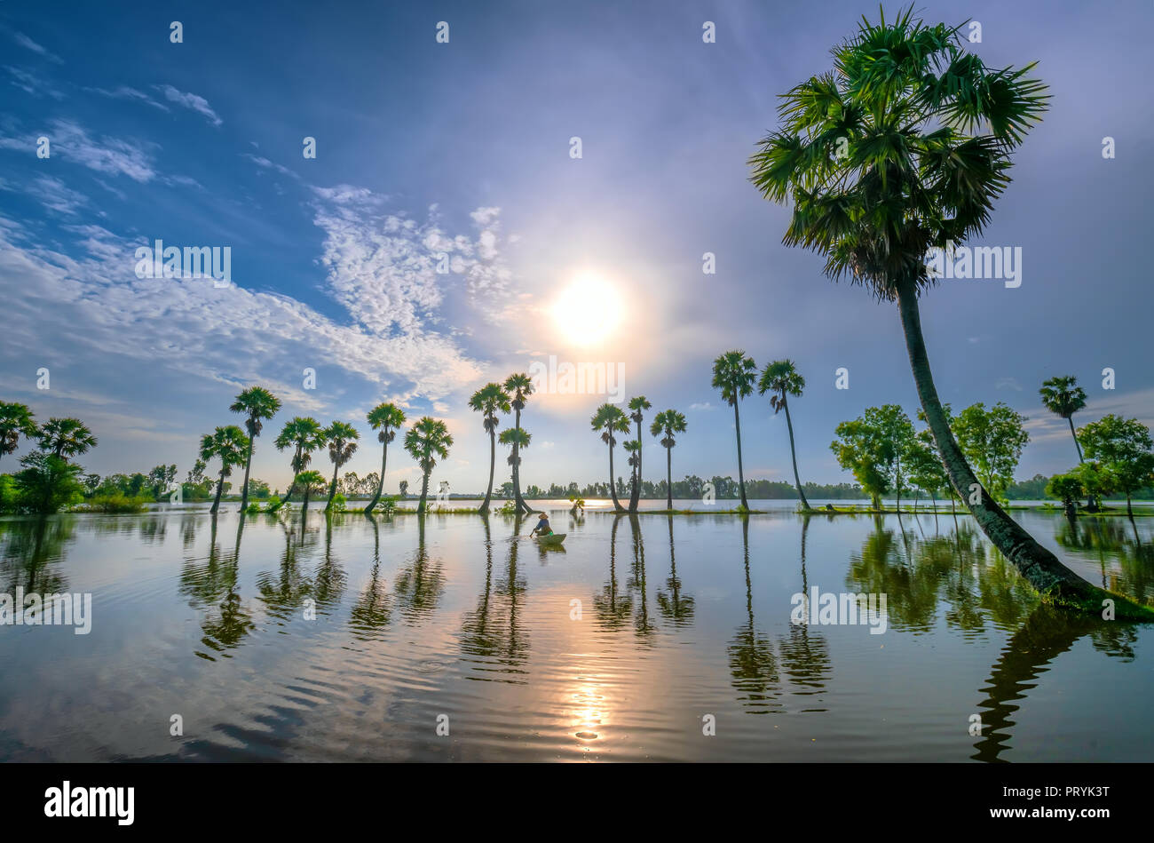Unidentified fishers spread a net to catch fish in a lake when sunrises ...
