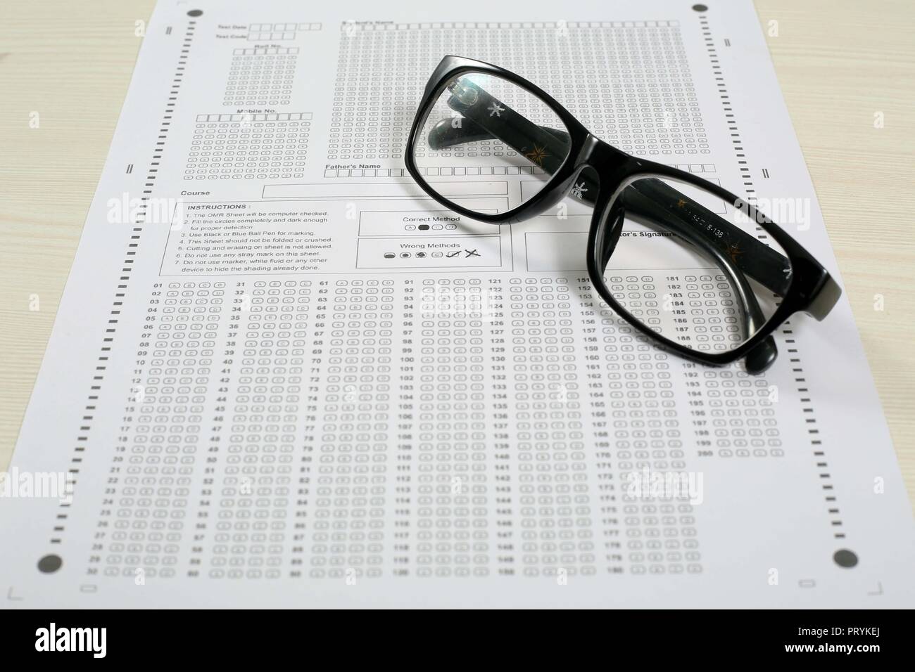 Picture of exam omr sheet and glasses. Isolated on white background ...