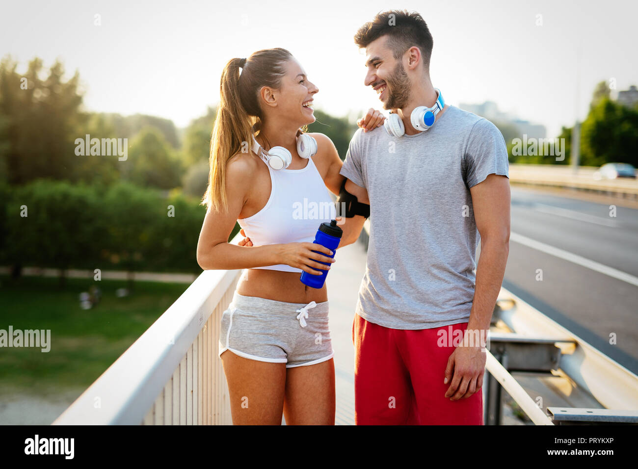 Couple jogging outdoors in the nature and smiling Stock Photo - Alamy