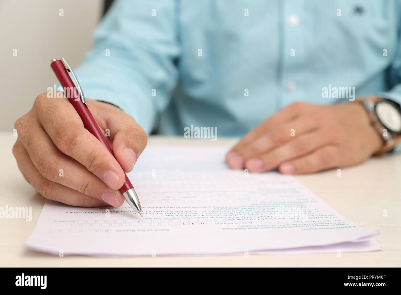 Picture of man hand on the form with pen Stock Photo - Alamy