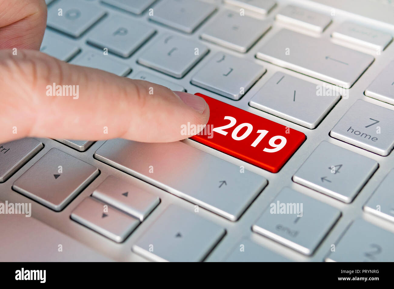 finger pressing keyboard key written 2019 newyear. finger presses a ...