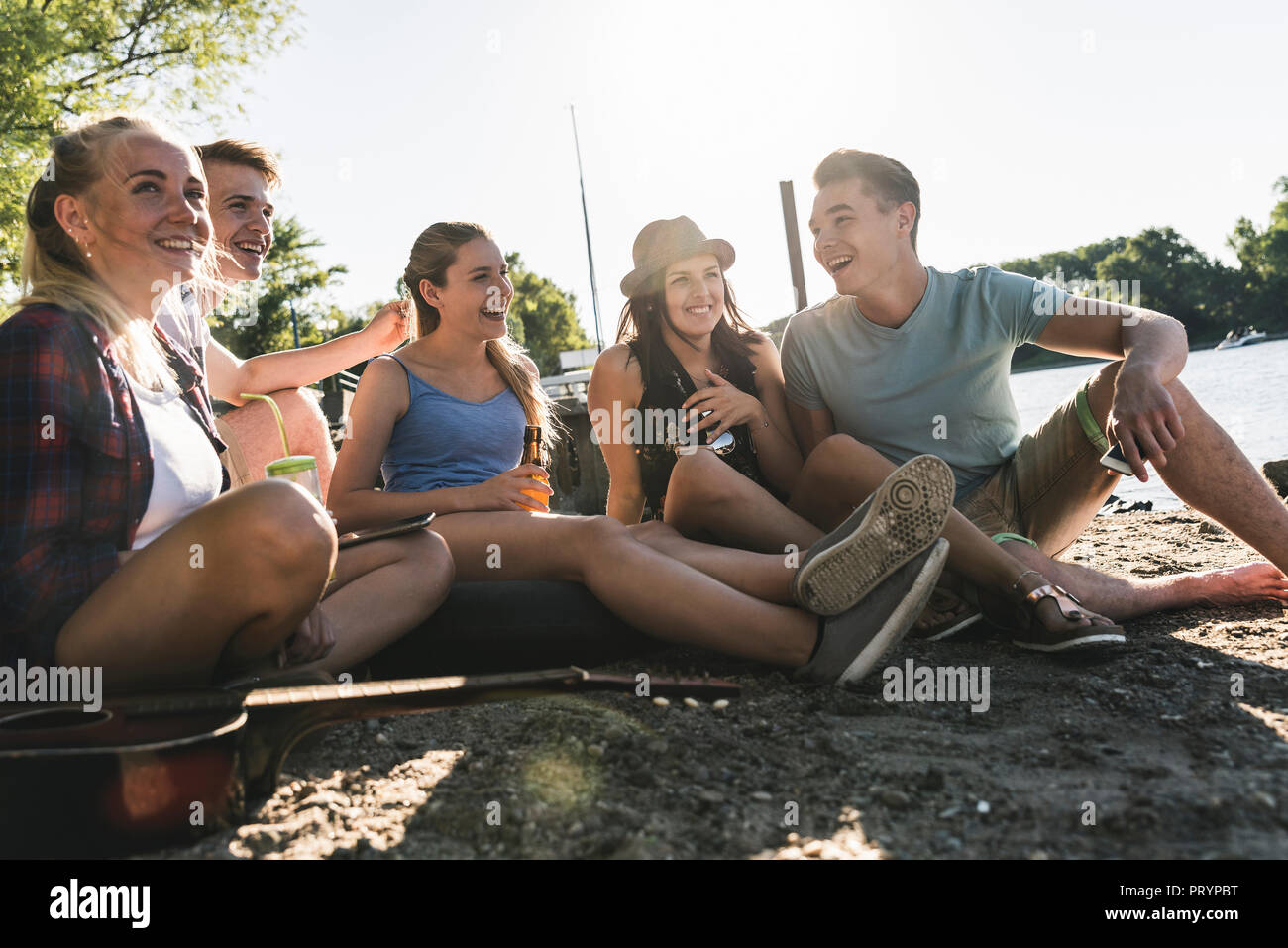 Group happy friends sitting hi-res stock photography and images - Alamy