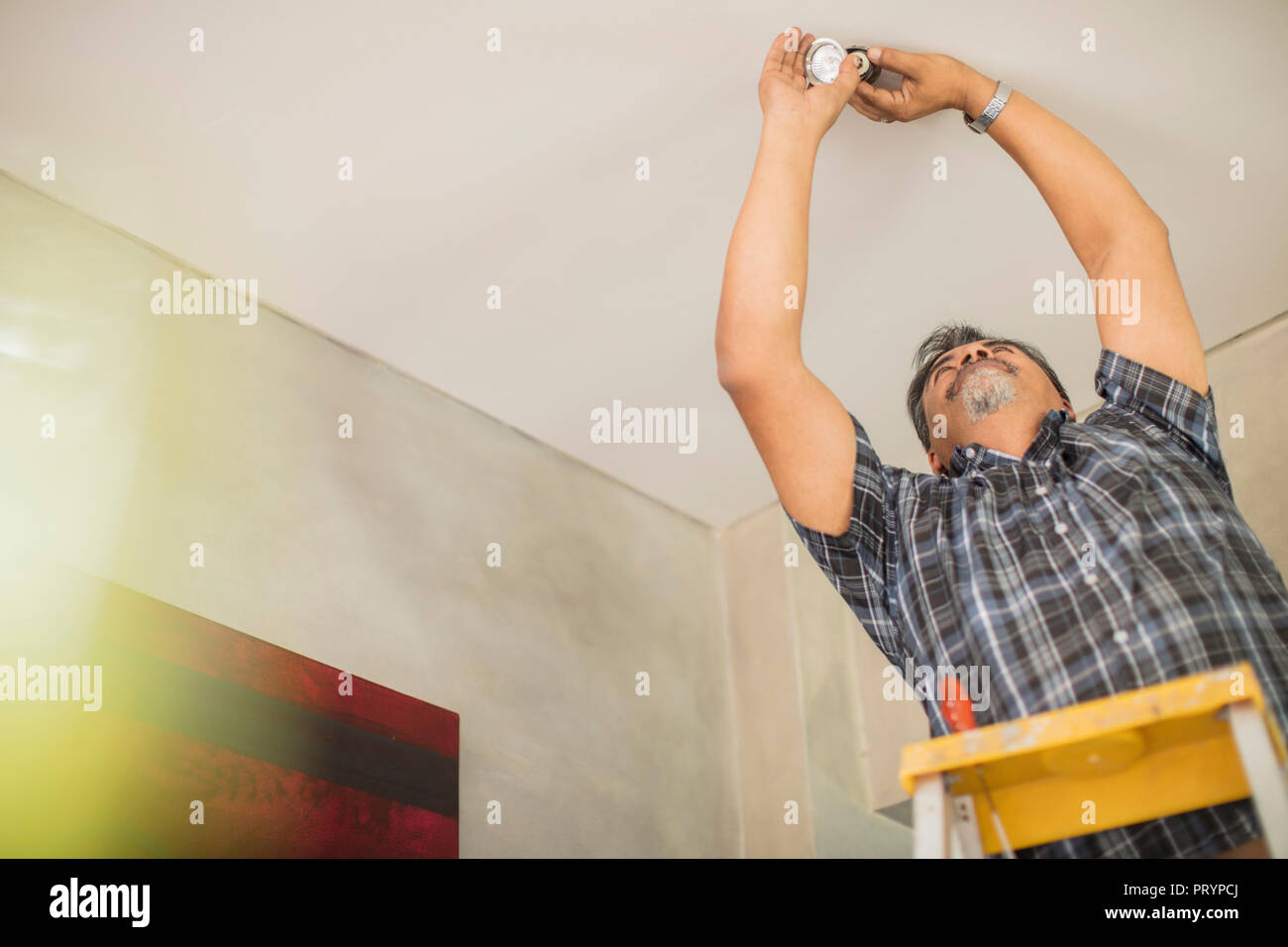 Man changing LED Stock Photo - Alamy