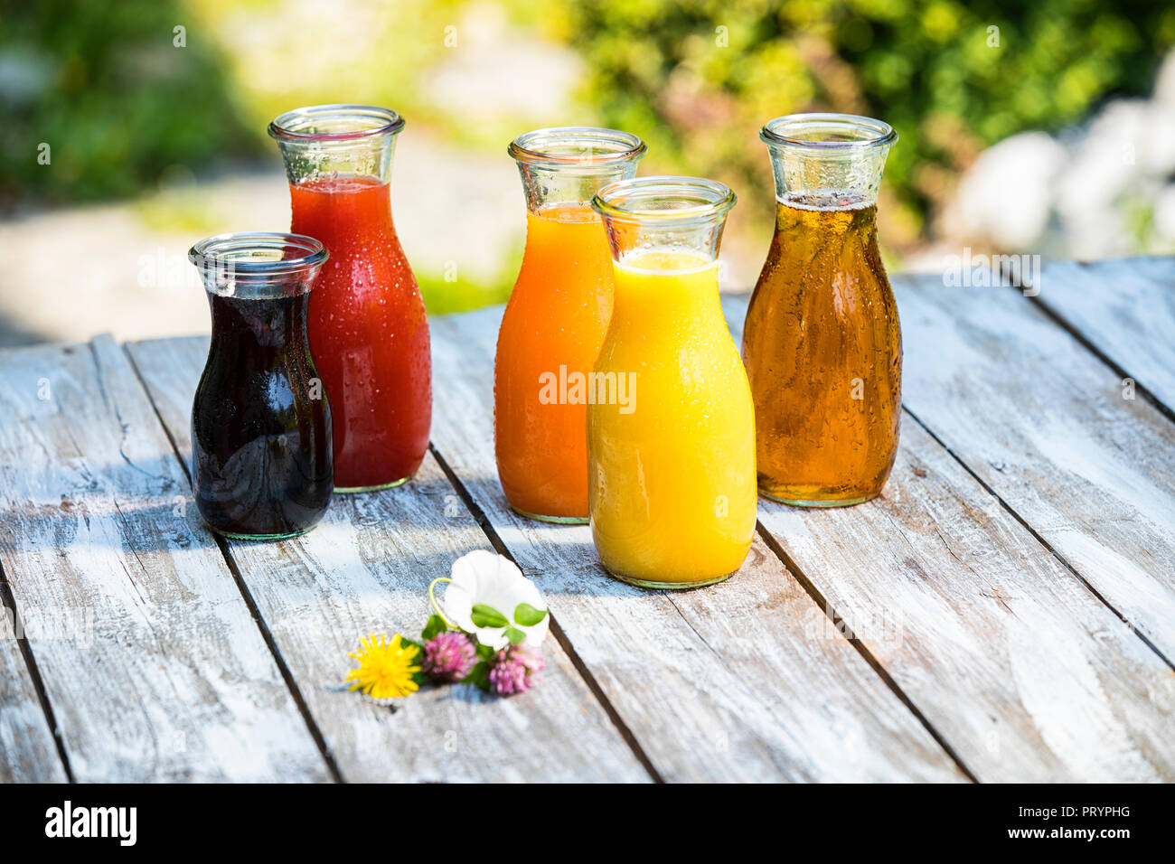 Glass bottles of various fruit juices Stock Photo - Alamy