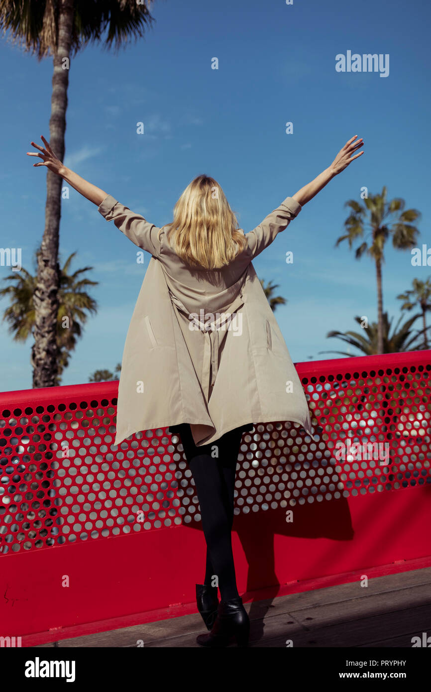 Back fashionable young woman wearing beige coat hi-res stock ...