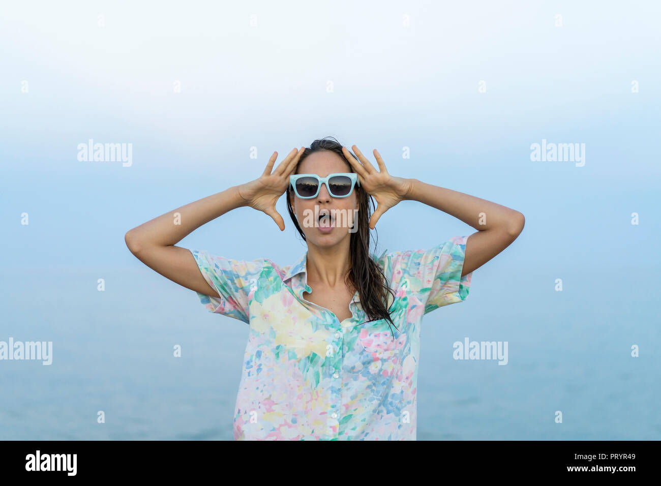 Portrait of scared woman in front of the sea Stock Photo - Alamy