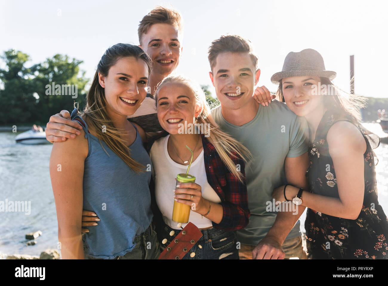 Portrait of group of happy friends at the riverside Stock Photo - Alamy