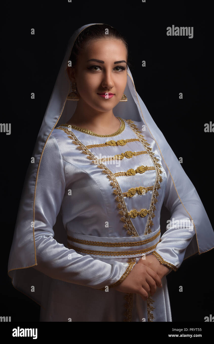 Beautiful Caucasus young girl wearing traditional costume. Studio shot ...
