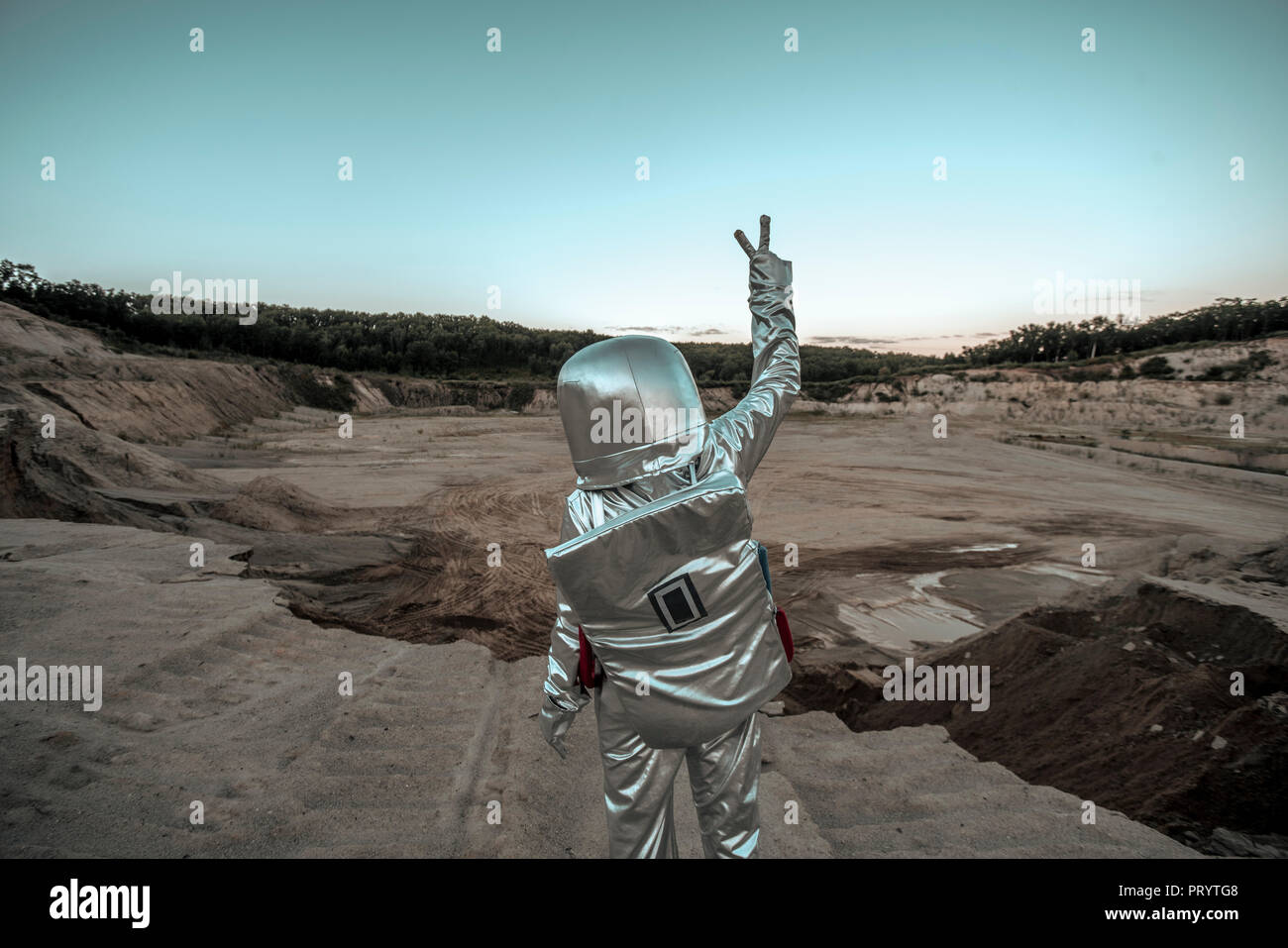 Spaceman making peace sign on a nameless planet Stock Photo - Alamy