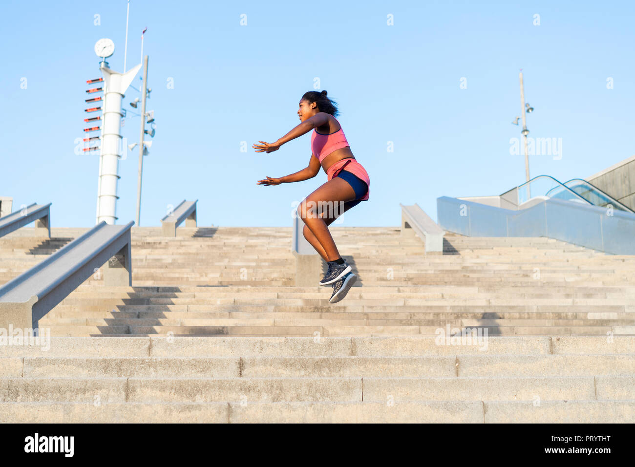 Young woman during workout on stairs, jumping Stock Photo - Alamy