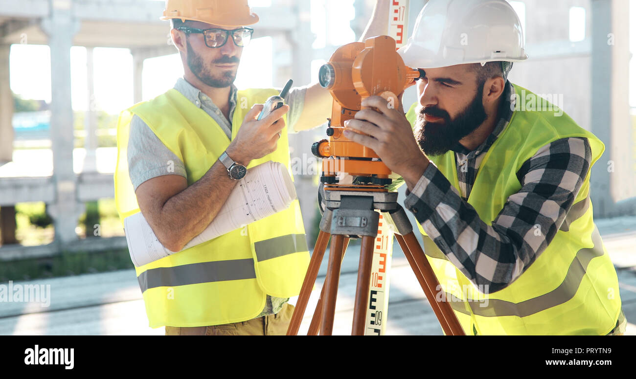 Construction engineers discussion with architects at construction site ...