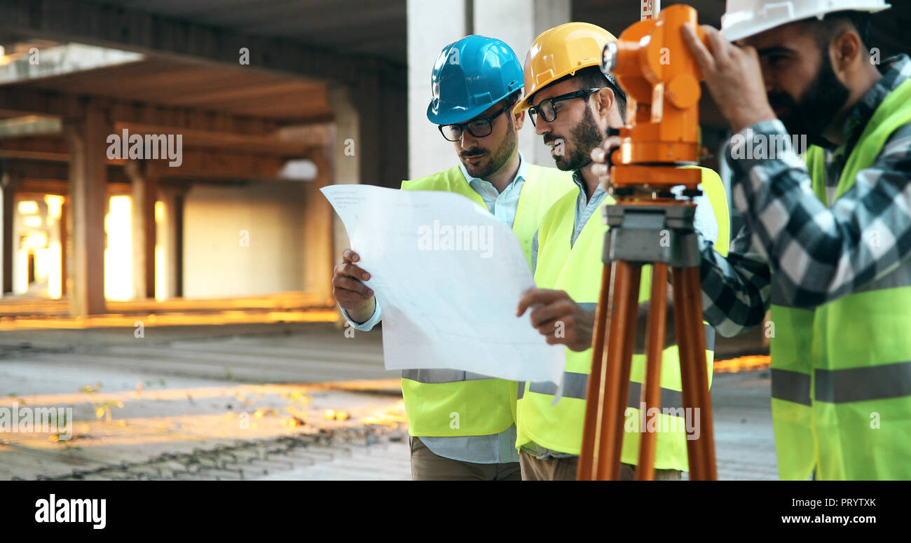 Portrait of construction engineers working on building site Stock Photo ...