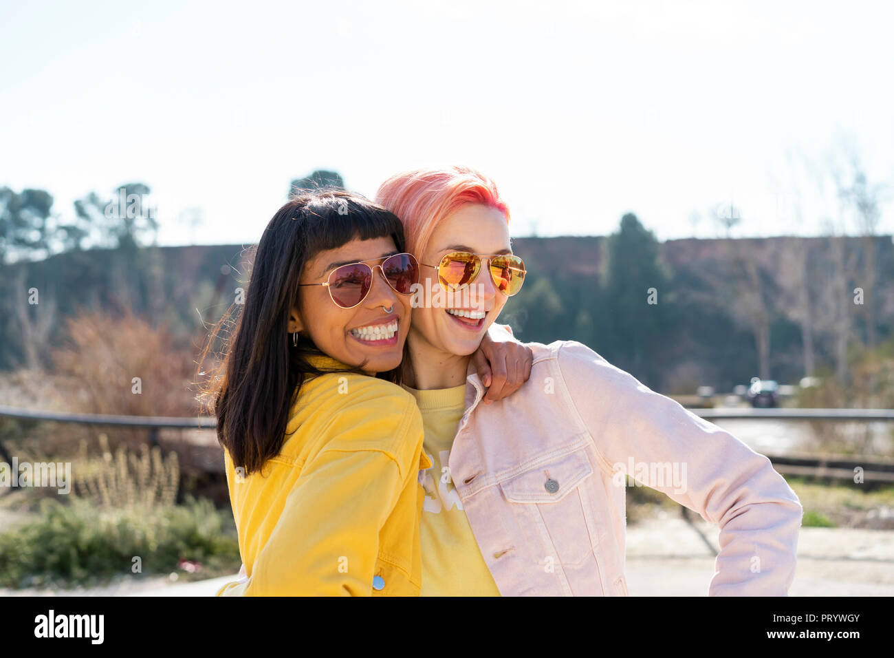 Portrait of two alternative friends embracing Stock Photo - Alamy
