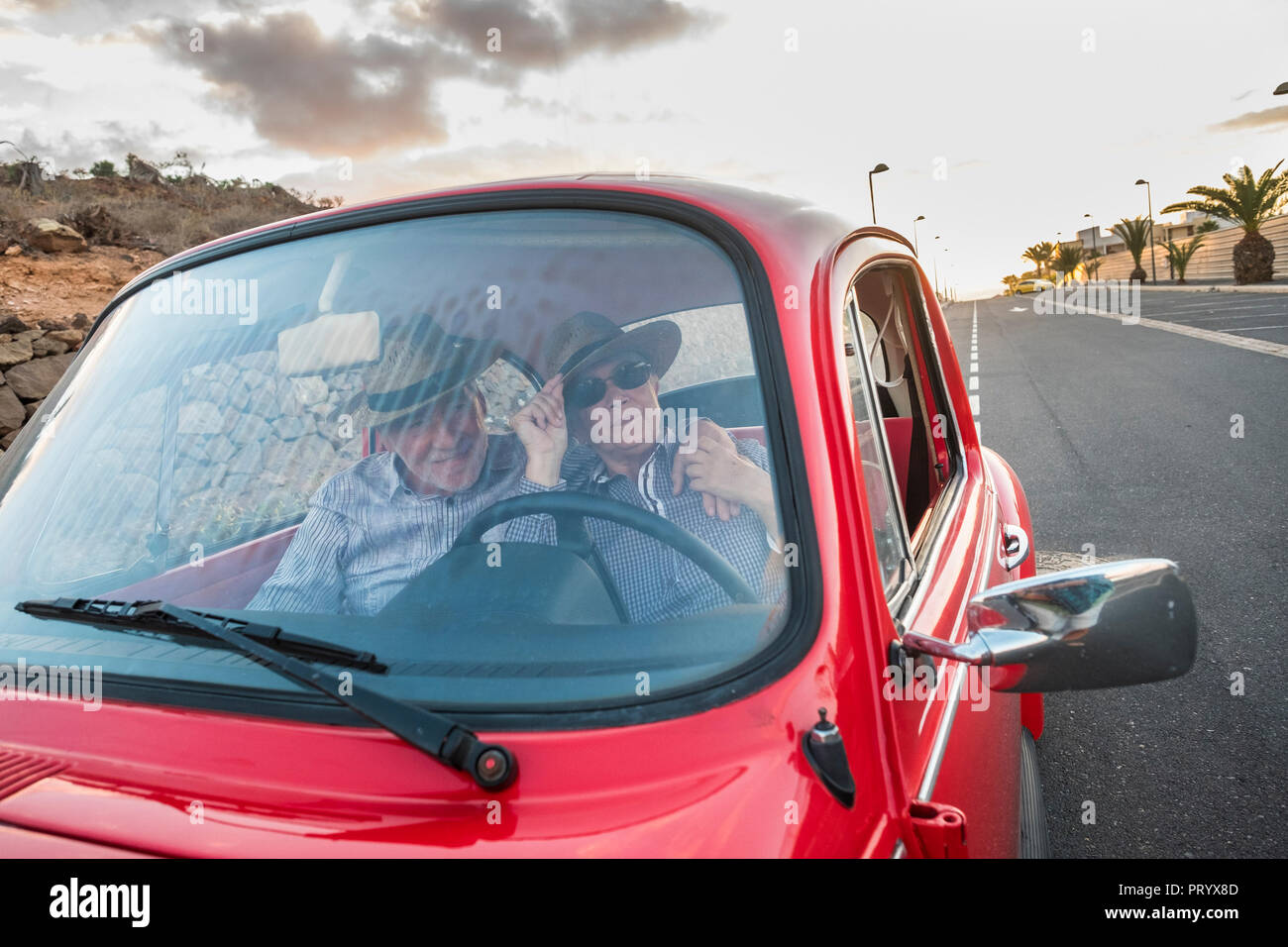 nice adult couple hug and love inside a red old vintage car parked on ...