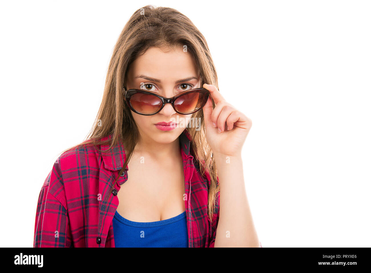 Young casual woman in sunglasses looking sceptically at camera isolated ...