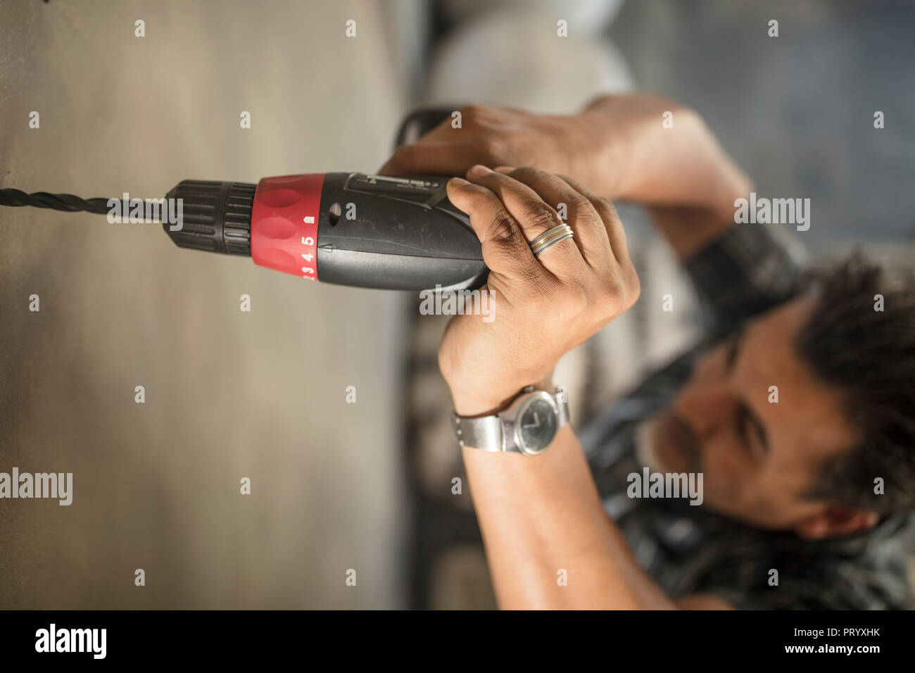 High angle view of man drilling with hand drill hi-res stock ...